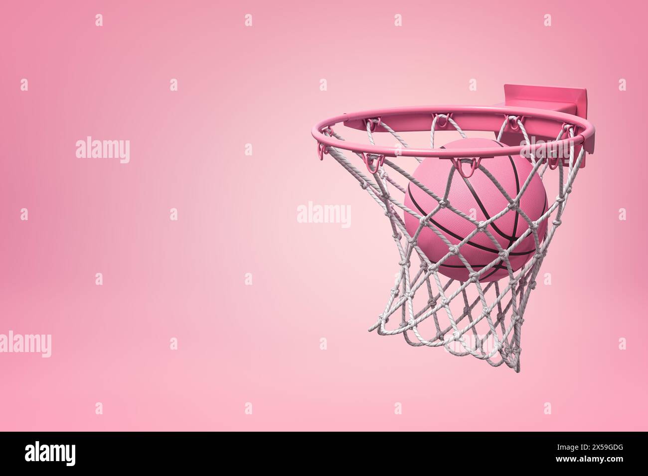 Basketball falling into pink hoop Stock Photo - Alamy