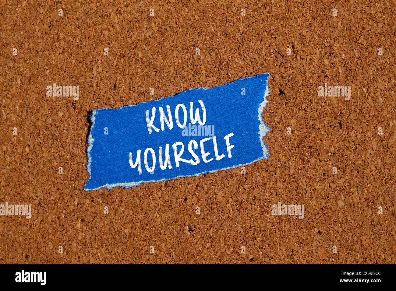 Know yourself words written on ripped blue paper piece with brown ...