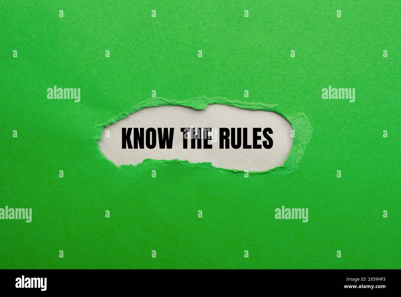 Know the rules words written on ripped green paper with gray background ...