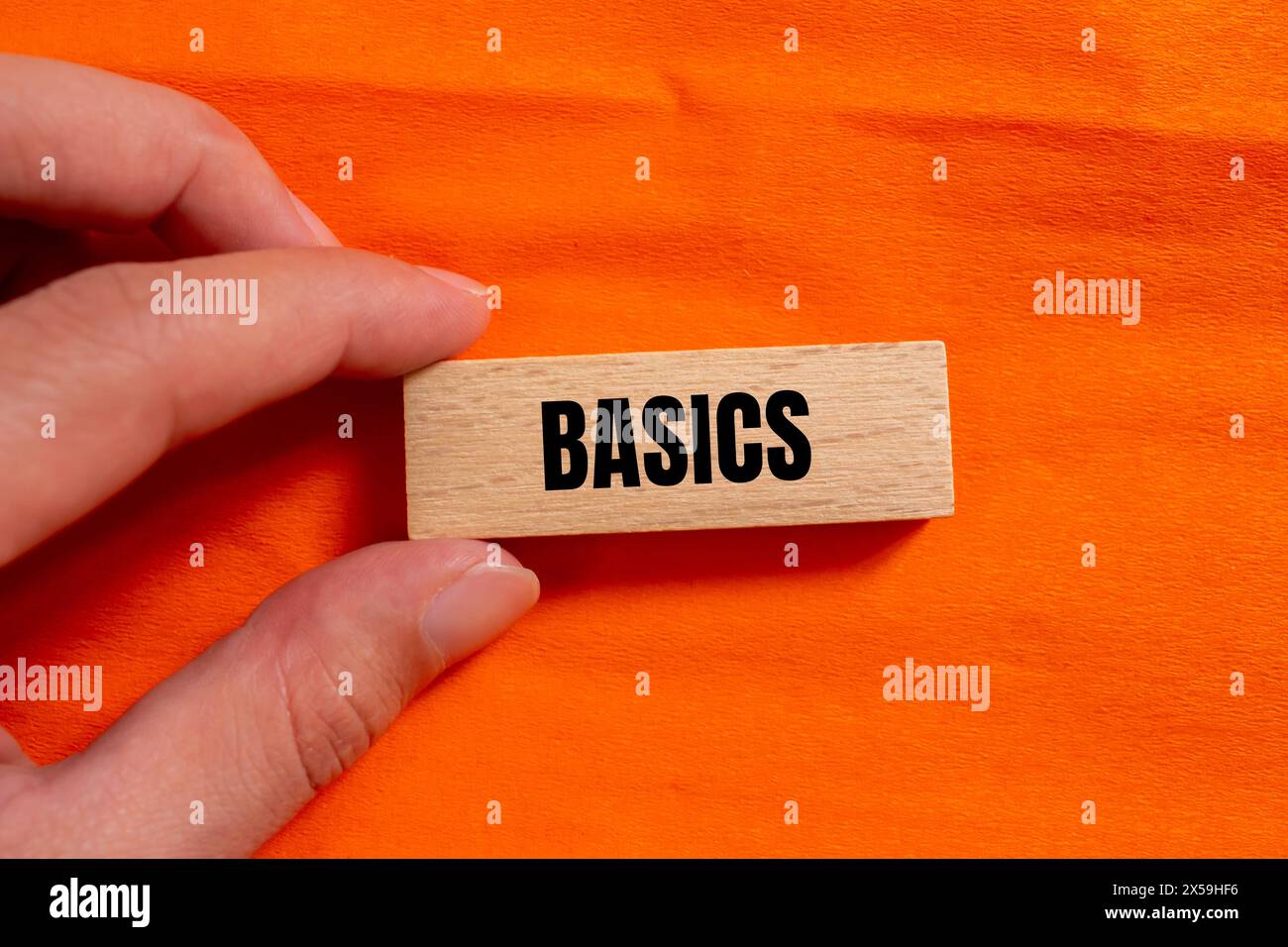 Basics word written on wooden block with orange background. Conceptual ...