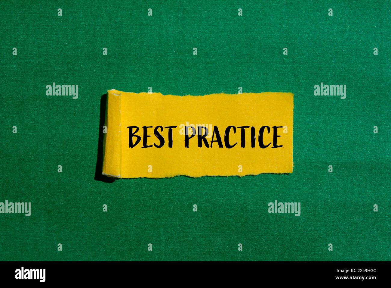 Best practice words written on ripped yellow paper with green ...