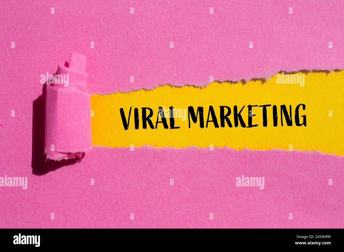 Viral marketing words written on ripped pink paper with yellow ...