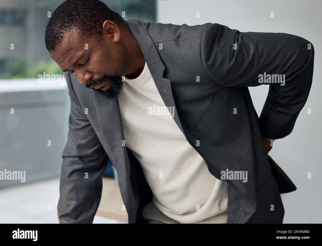 Stress, burnout and black man in office with back pain, accident or ...