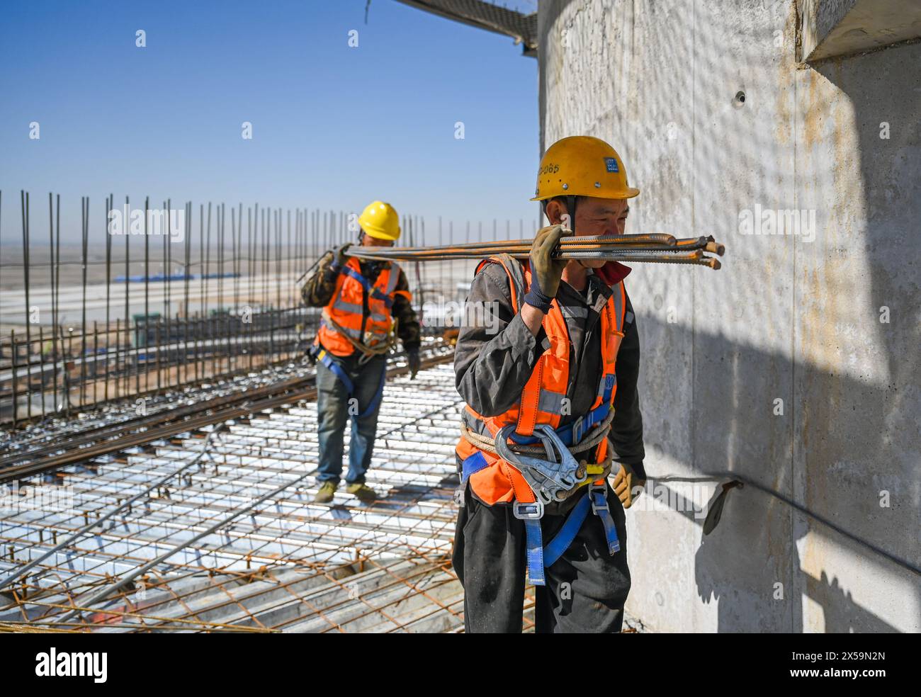 (240508) -- HOHHOT, May 8, 2024 (Xinhua) -- Workers carry construction ...