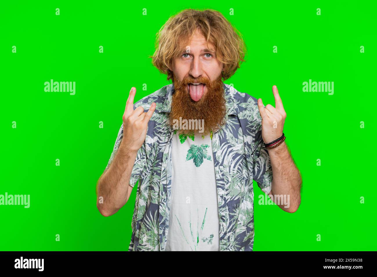 Overjoyed happy young caucasian man showing rock n roll gesture by ...