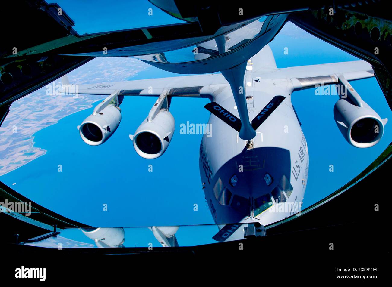 A KC-135 Stratotanker from the 121st Air Refueling Wing refuels a C-17 ...