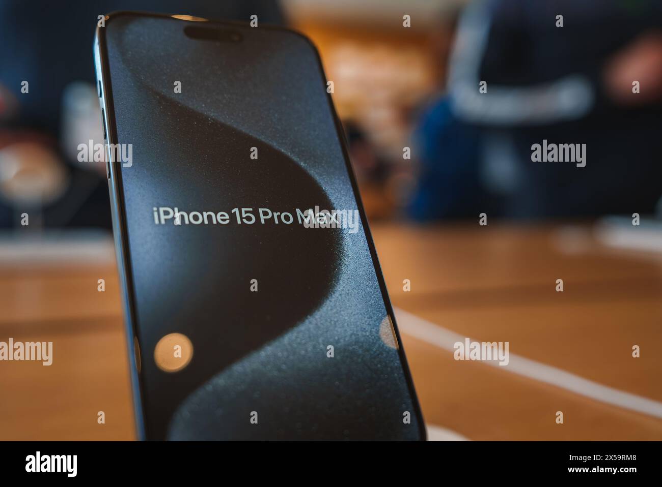 Close Up View Black iPhone 15 Pro Max, Store Interior Background, Warm ...