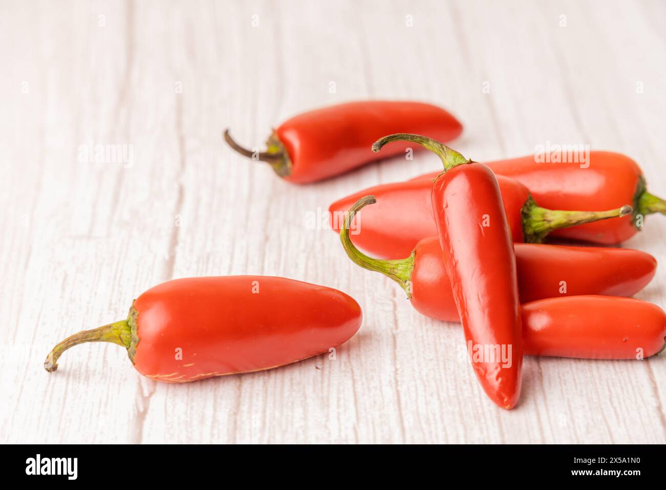 red hot chili peppers in wooden white background table. Natural organic ...