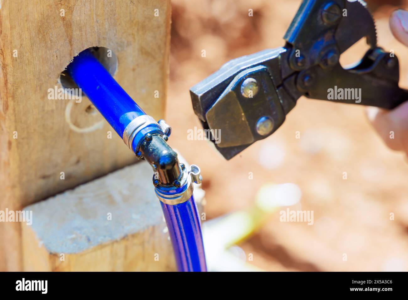Plumber connects blue PVC pipe for water piping system Stock Photo - Alamy