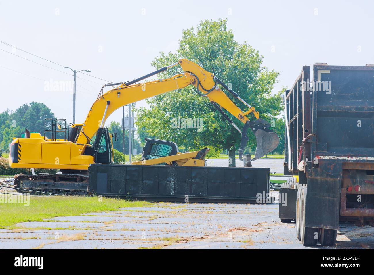Construction concrete waste is loaded into dump container by an ...