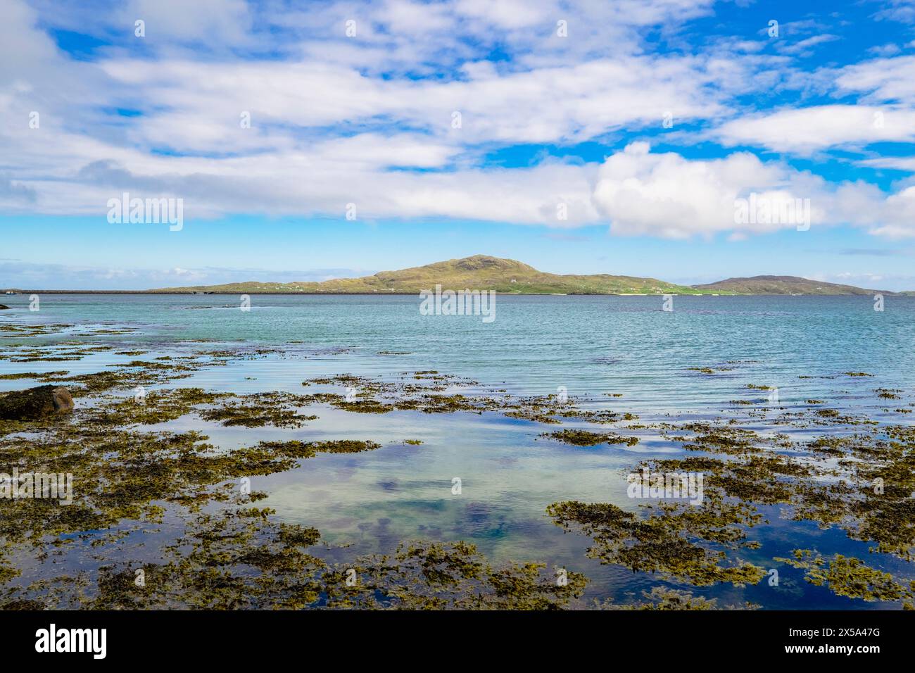 View across the calm sea to Eriskay island from Kilbride, South Uist ...