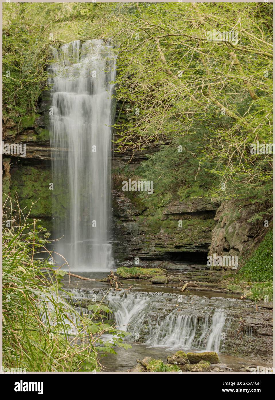 A series of waterfalls cascading down a hillside running towards an ...