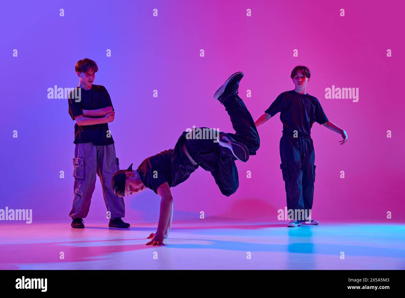 Group of talented boys in sports attire performing dance moves mixed ...