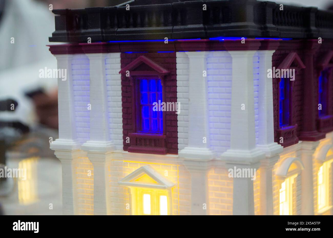 Prototype printed on 3D printer brick building with columns and glowing ...