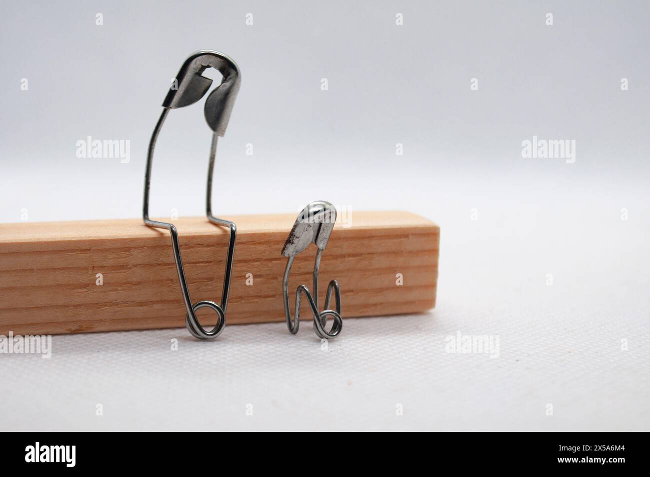 Model safety pin of mother or farther comforting his of her son. Family ...