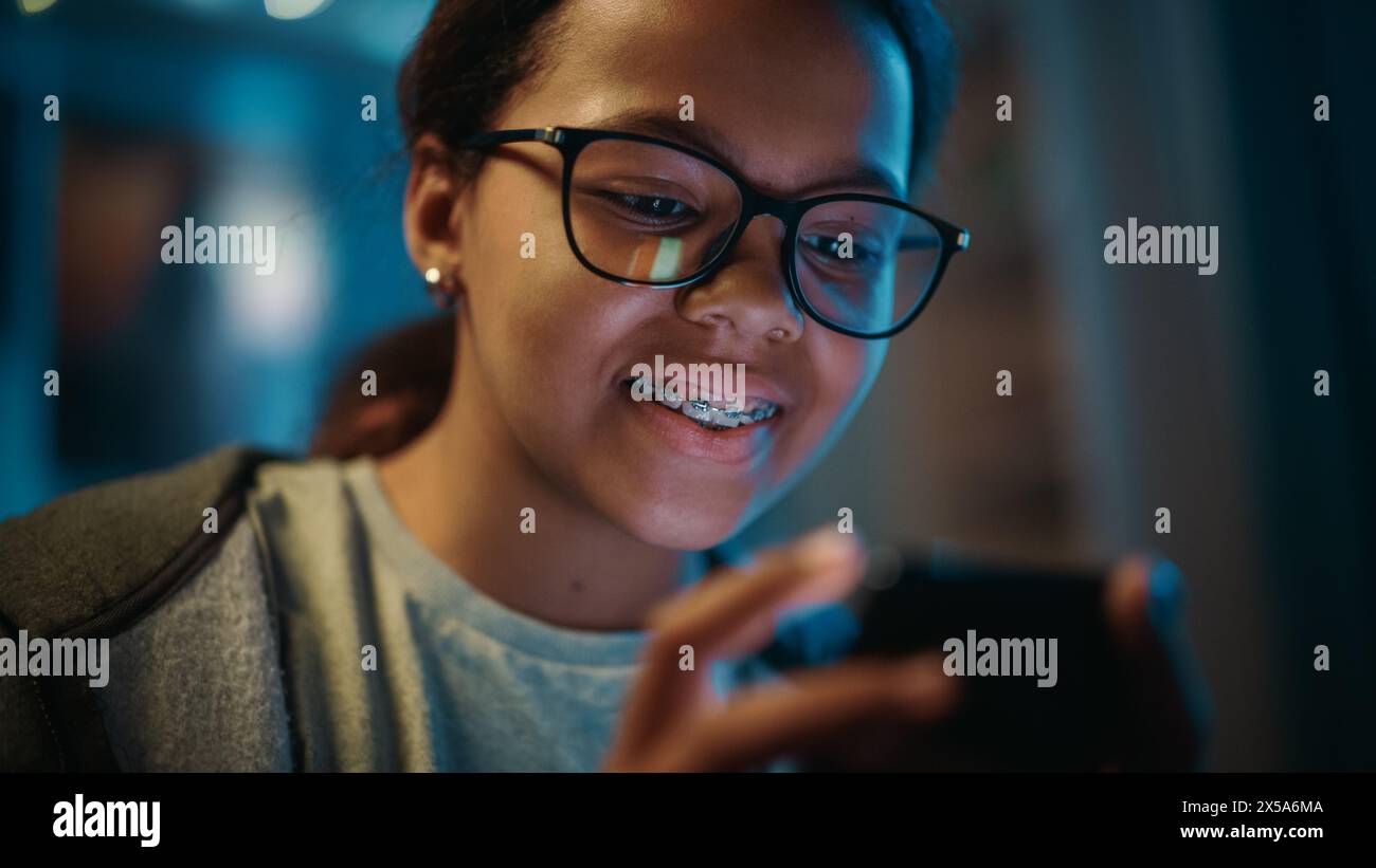 Portrait Of A Teenage Multiethnic Black Girl Using A Smartphone Young