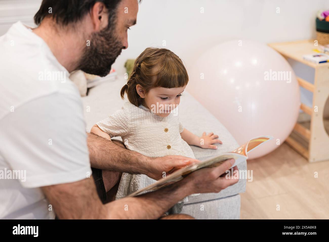 A heartwarming image capturing a father and his young daughter ...