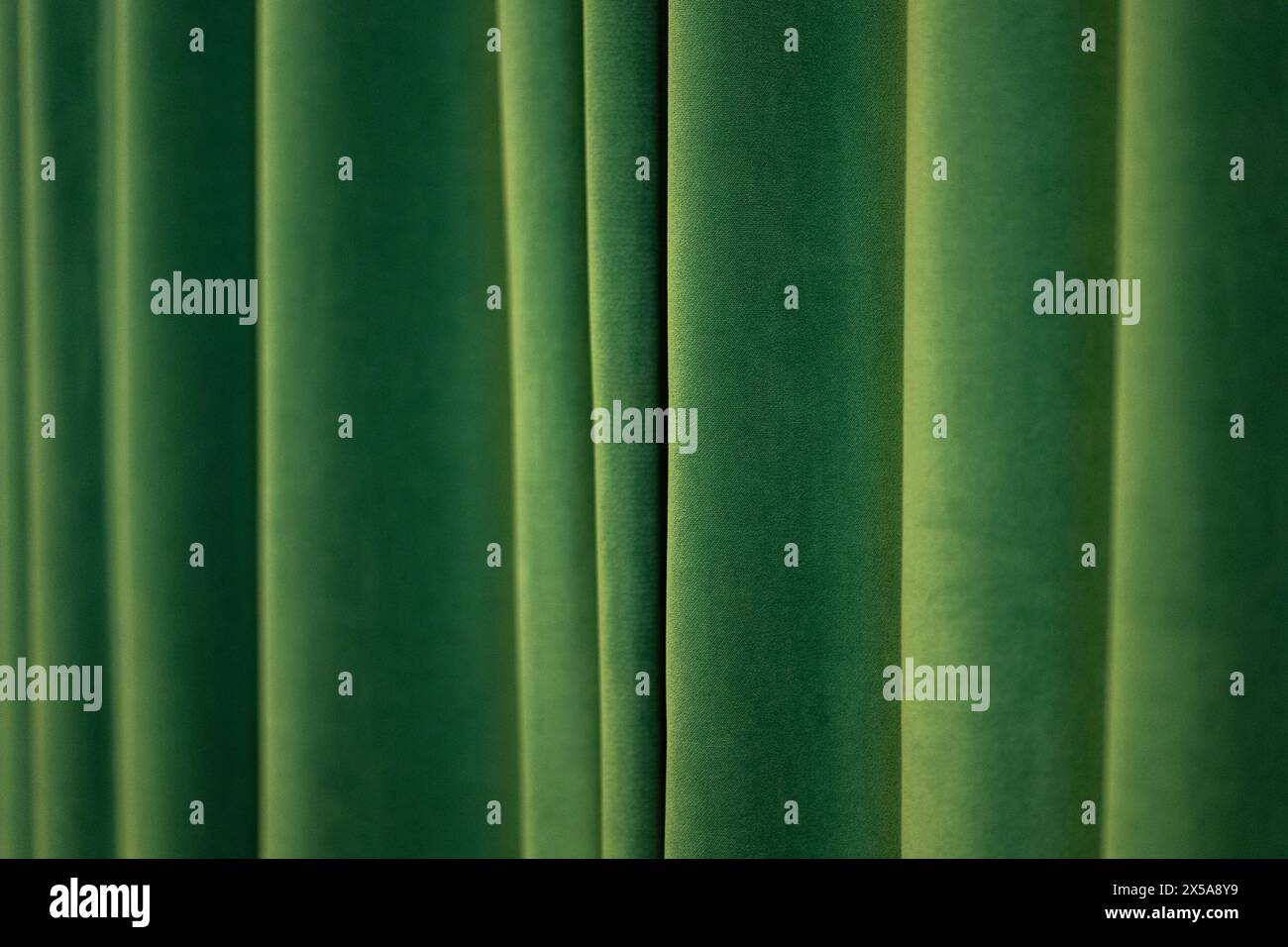 This image captures the luxurious texture of velvet curtains in a green ...
