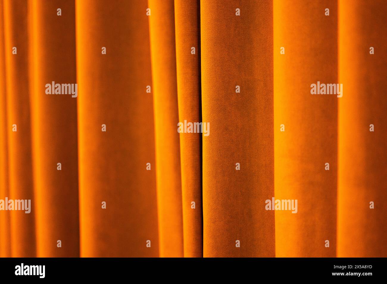 This image captures the luxurious texture of velvet curtains in a warm ...