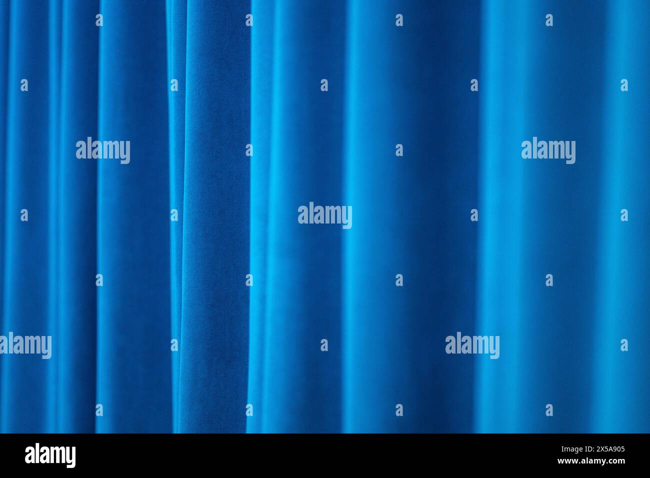 This image captures the luxurious texture of velvet curtains in a blue ...