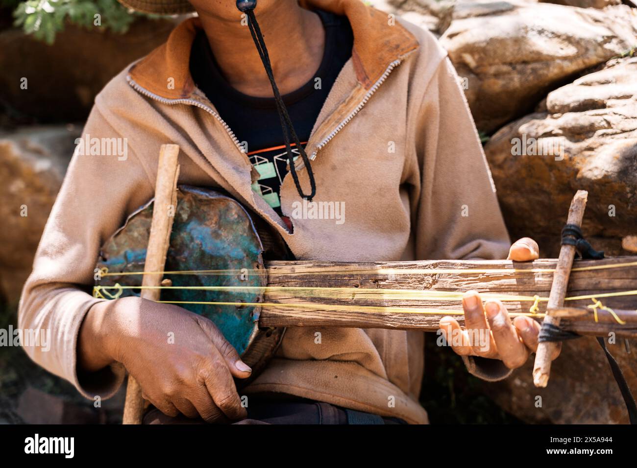 Close-up of a cropped unrecognizable African musician's hands playing a ...