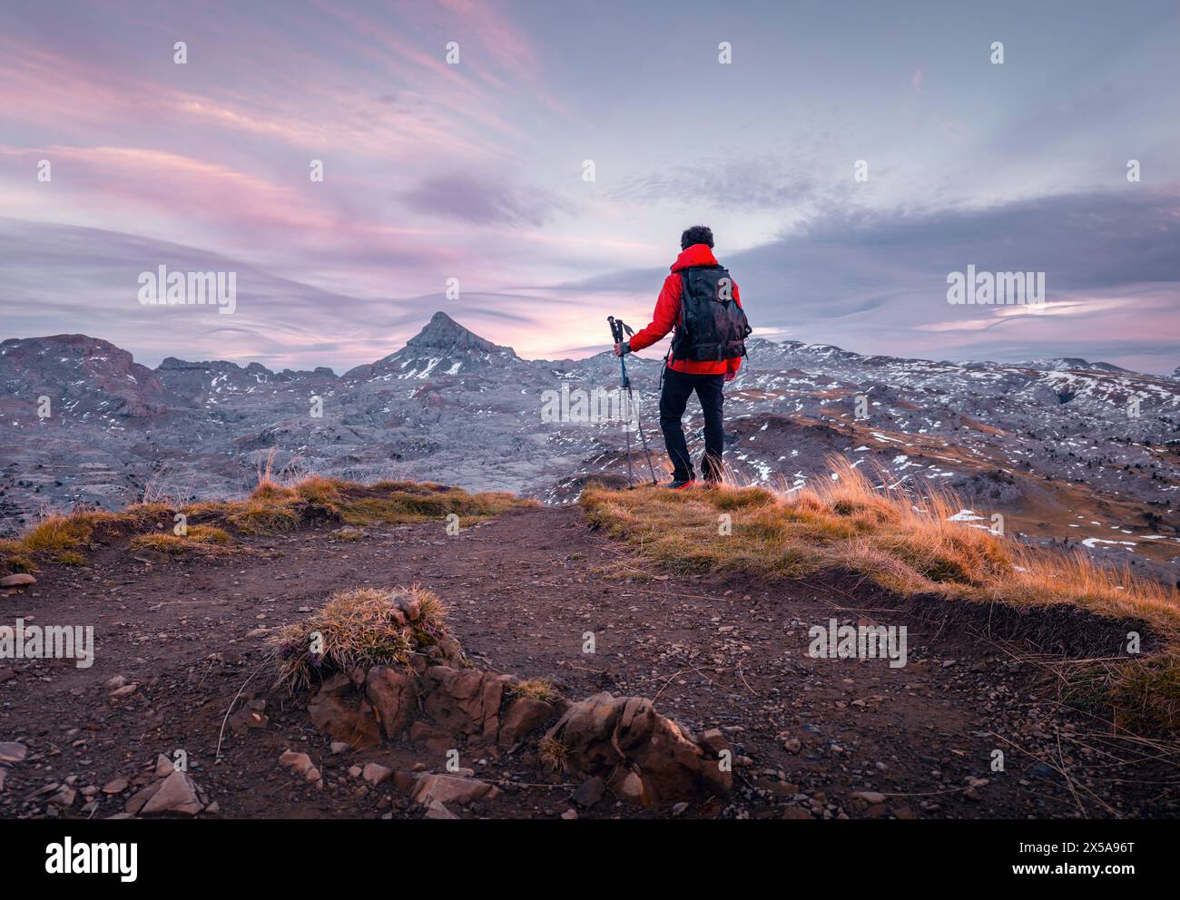 Back view of unrecognizable solitary hiker stands facing the iconic Pic ...