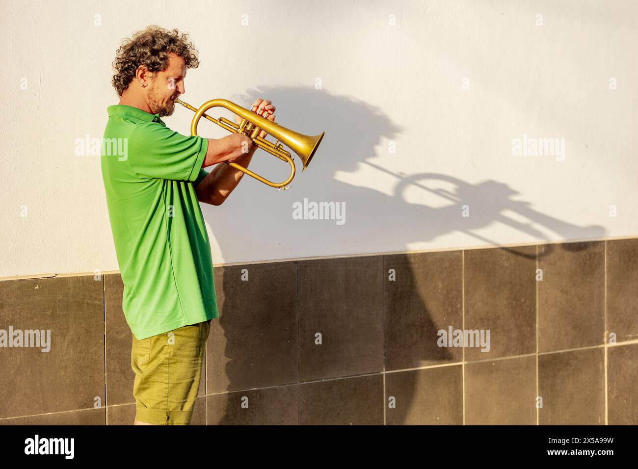 Side view of an inspiring sight of a one-armed man skillfully playing ...