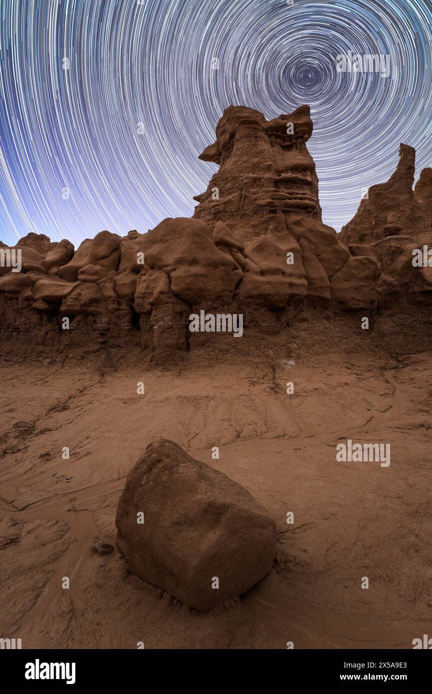 Striking night sky filled with circular star trails above unique hoodoo ...