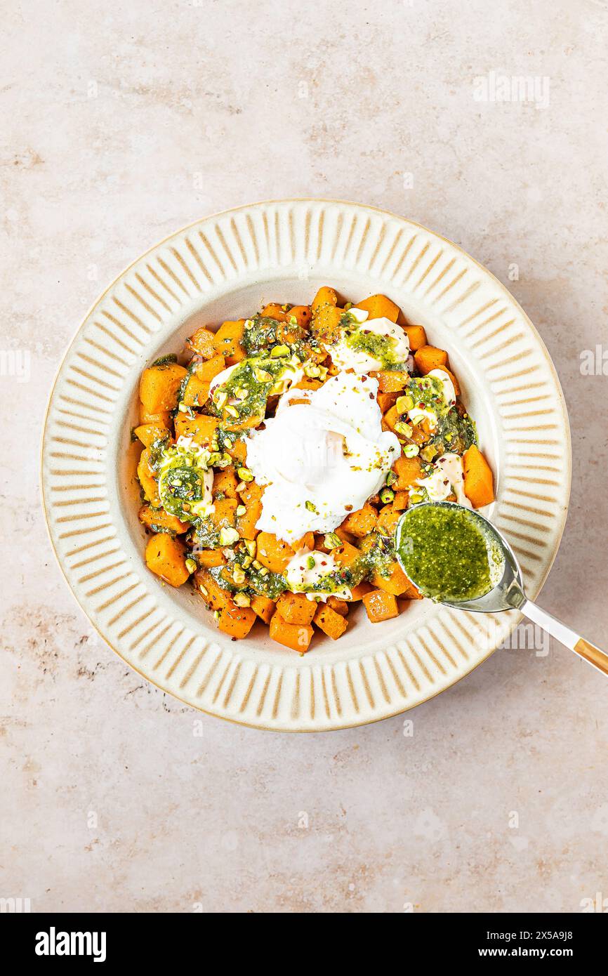 A colorful top view image of roasted butternut squash topped with ...