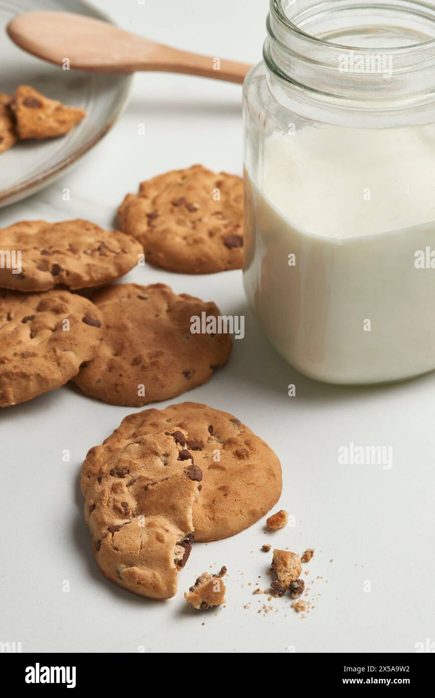 A top-down view of a homely snack scene with chocolate chip cookies and ...