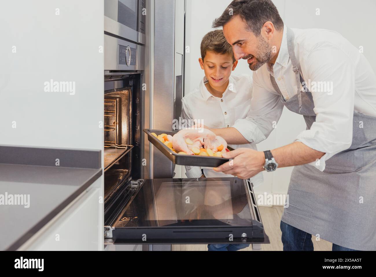 A heartwarming scene of family bonding as a father and his young son ...