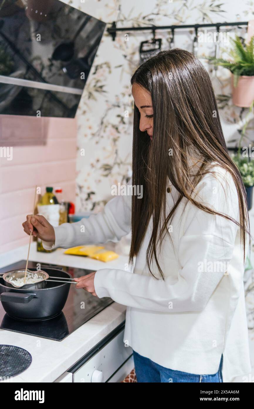 Woman cooks in kitchen hi-res stock photography and images - Alamy