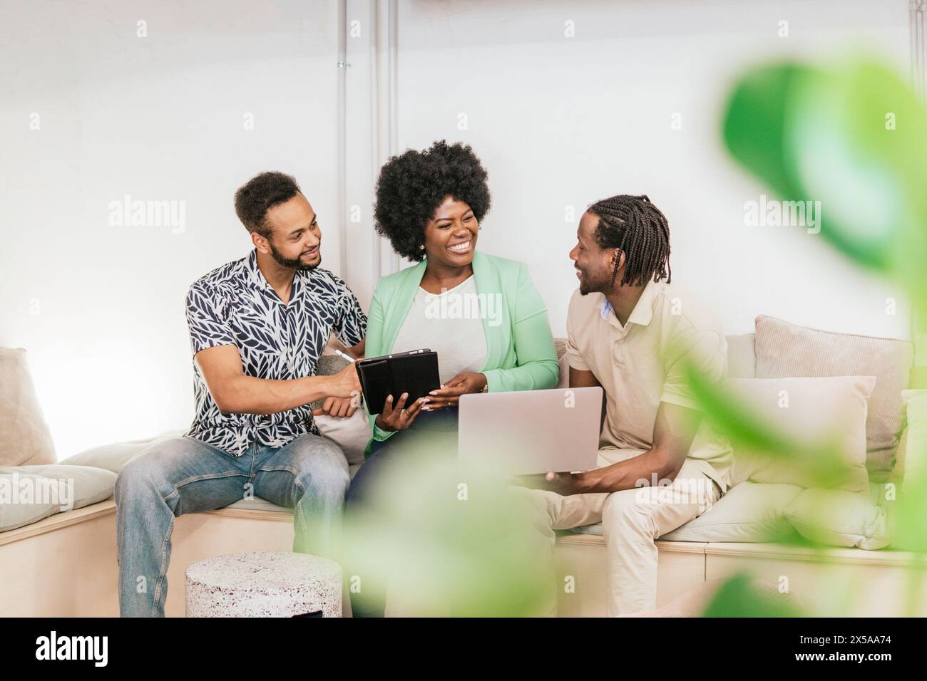 Three diverse professionals engaging in a collaborative work session in ...