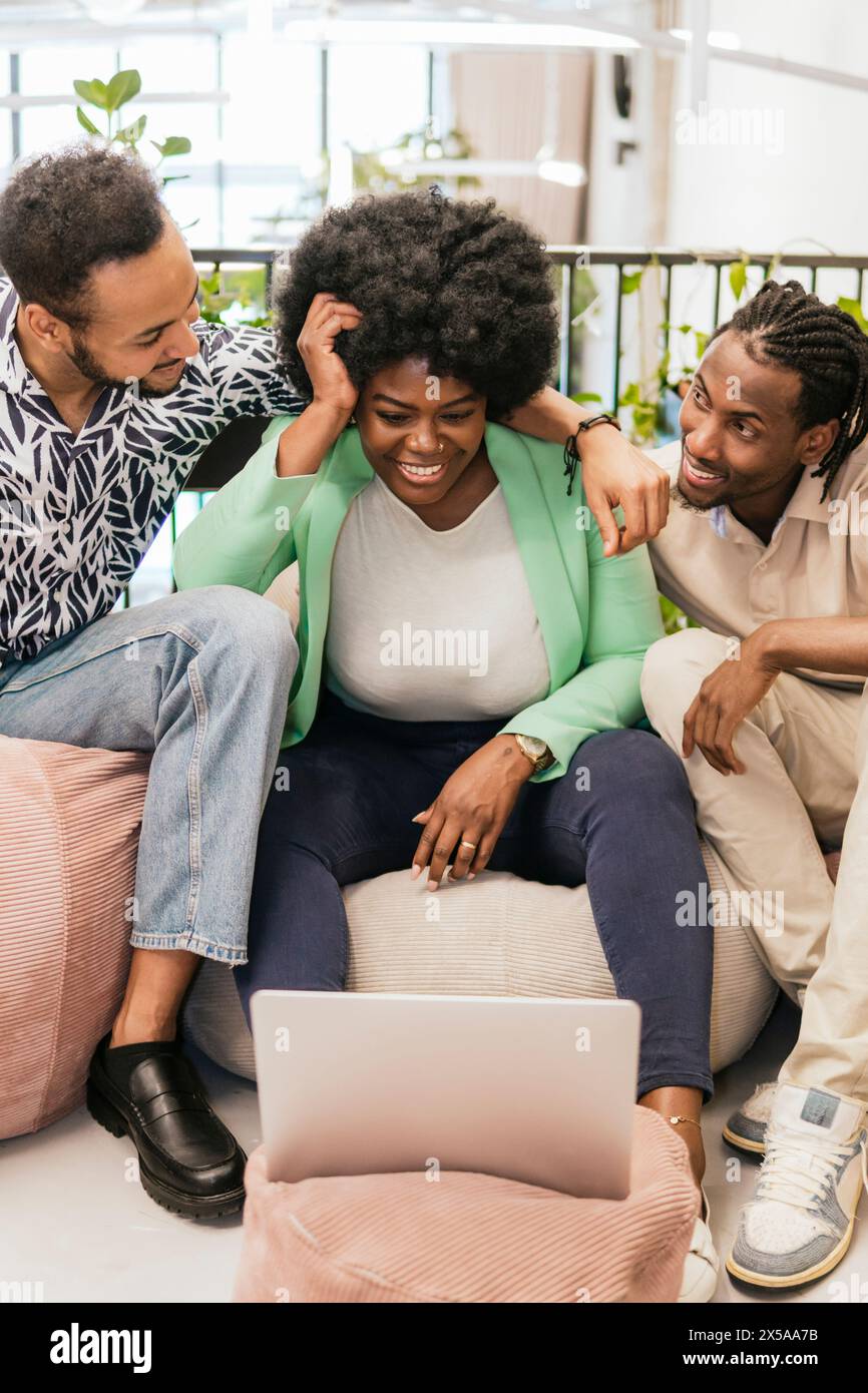 Three young professionals participate in an informal brainstorming ...