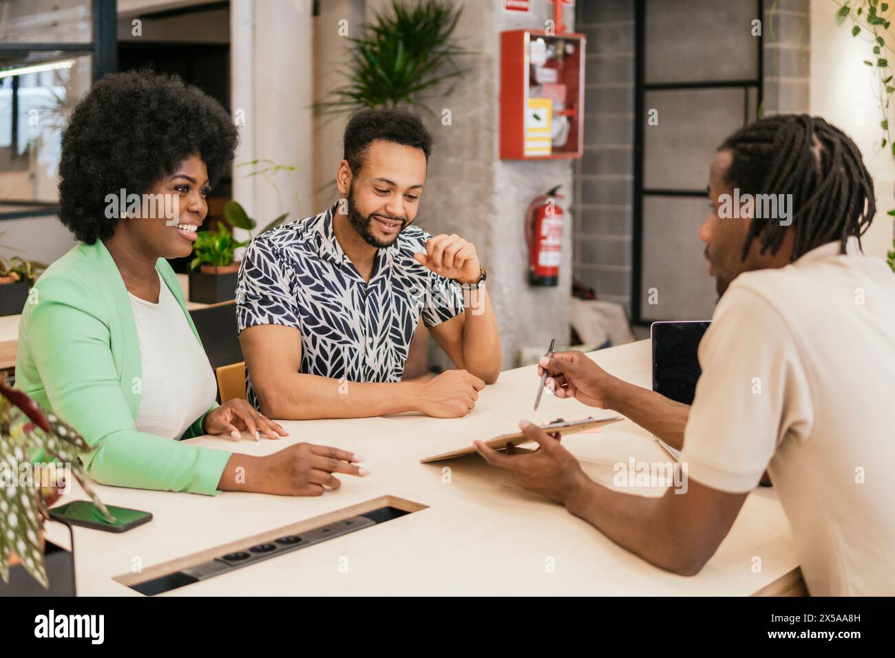Three professionals engaging in a productive meeting at a coworking ...