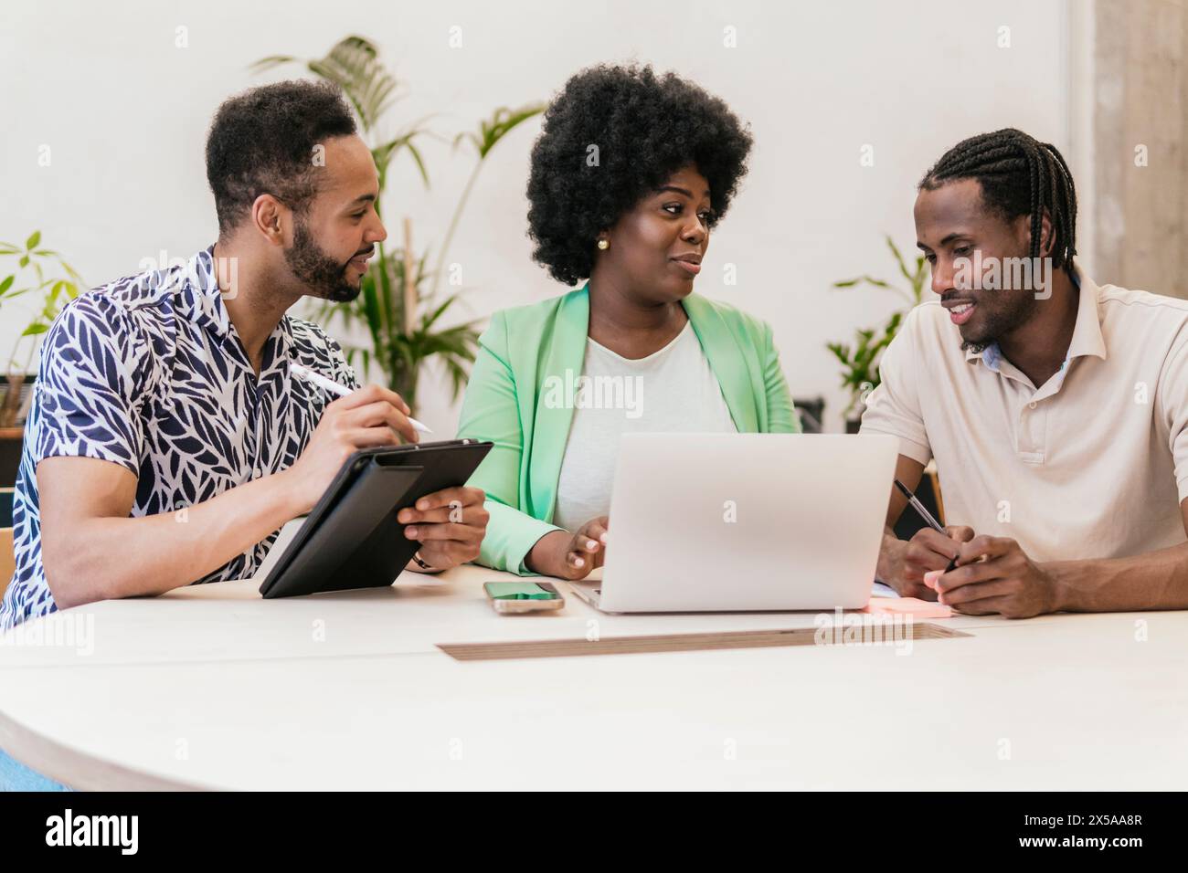 A multiethnic group of professionals collaborating on a project in a ...