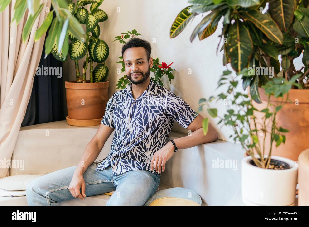 Stylish man lounges comfortably hi-res stock photography and images - Alamy