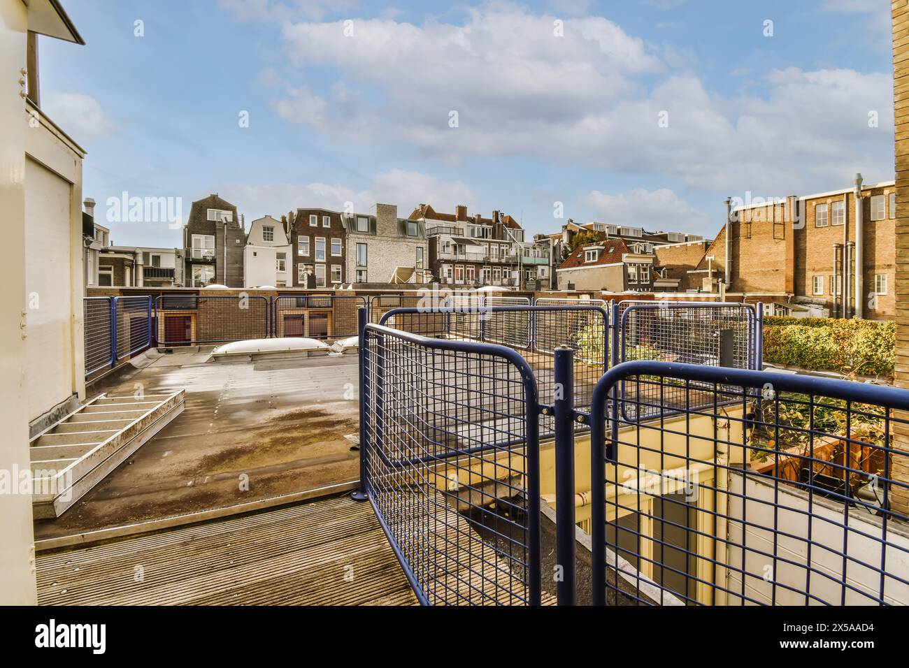 A clear day over an urban rooftop showcasing neighboring residential ...
