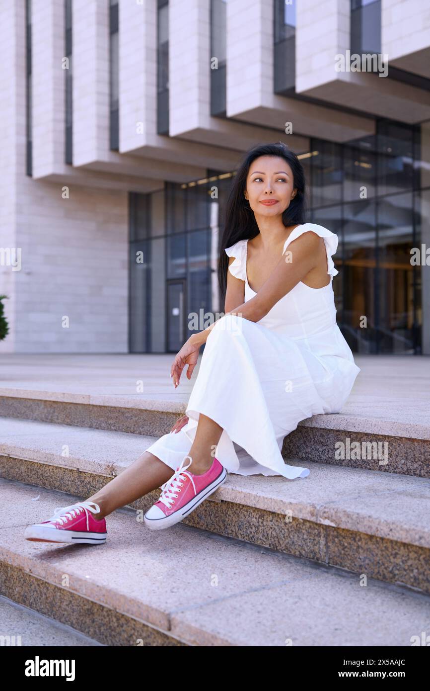 Beautiful woman relaxing on a urban street stairs Stock Photo - Alamy