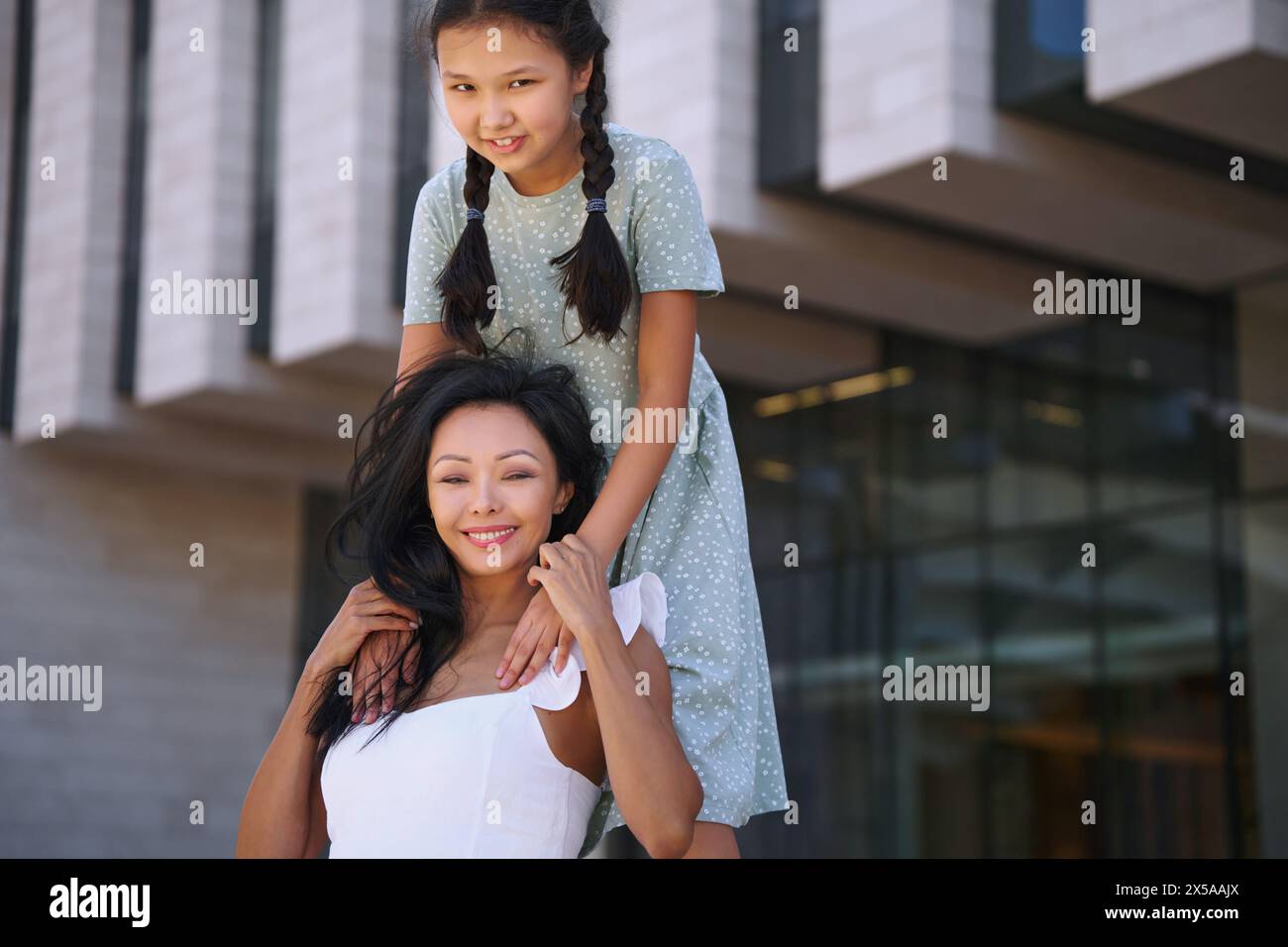 Girl with autism spectrum having fun with her mother while walking in ...