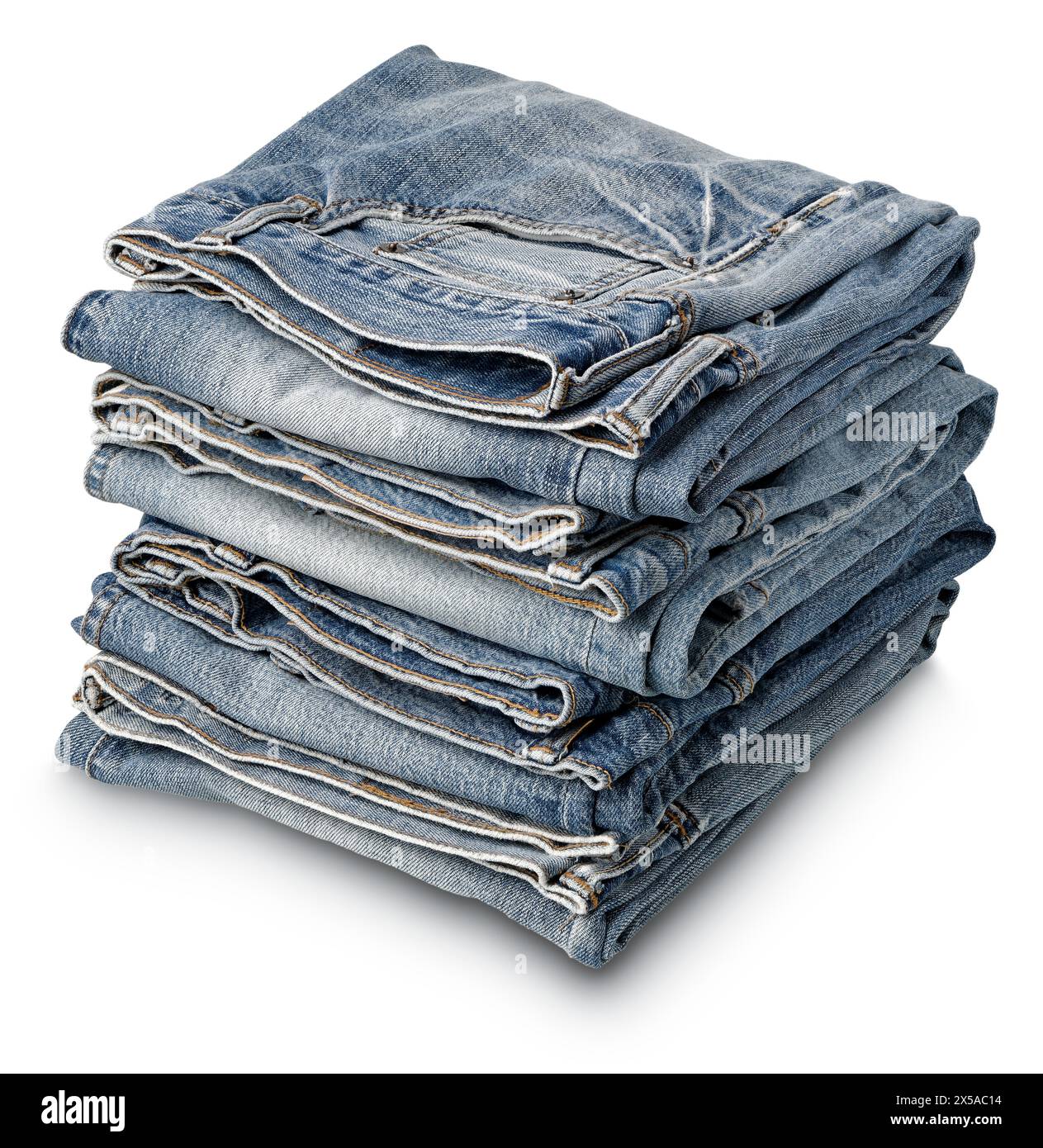 Stack of folded aged blue denim jeans, isolated on white background ...