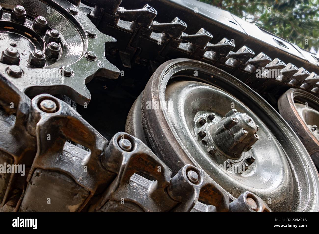 A closeup of tracks of an old tank. The part of tank with a large ...