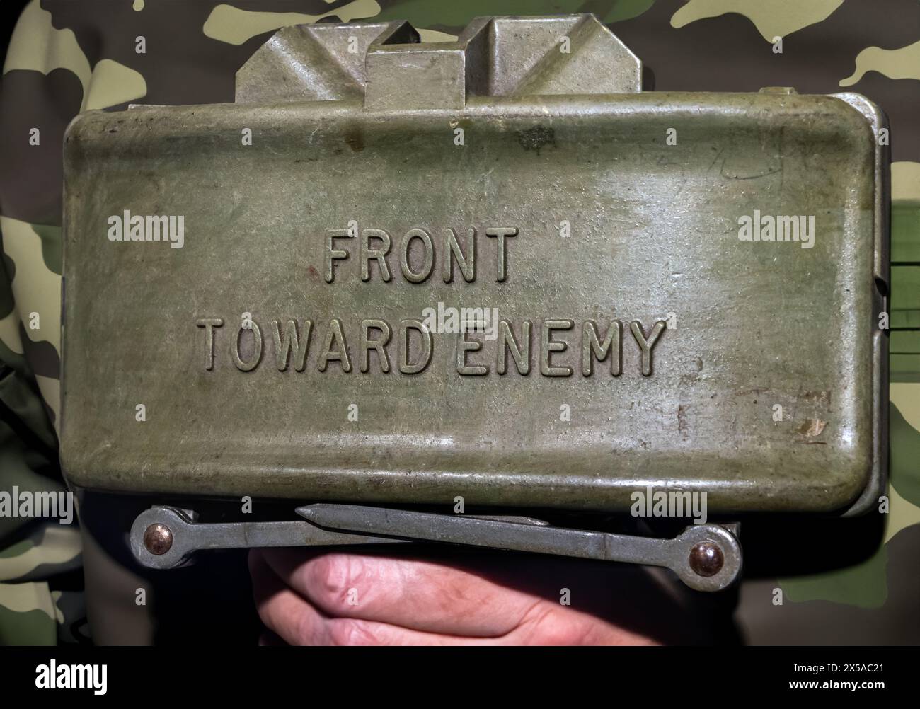 A man in a camouflage uniform holds an anti-personnel mine Stock Photo ...