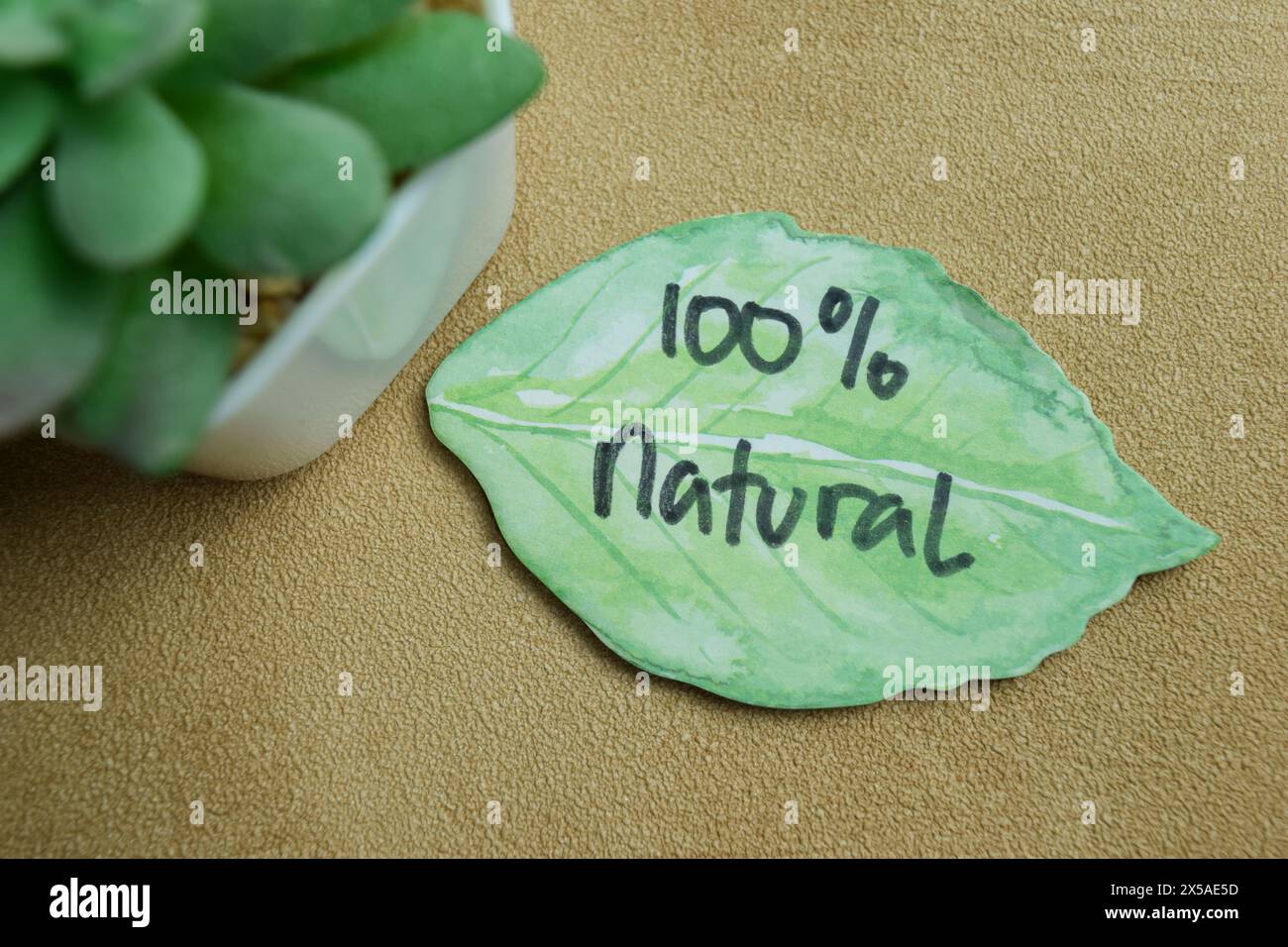 Concept of 100 % Natural write on sticky notes isolated on Wooden Table ...