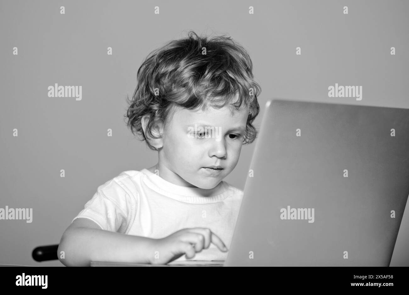 Cute clever boy pupil with laptop. Child from elementary school ...
