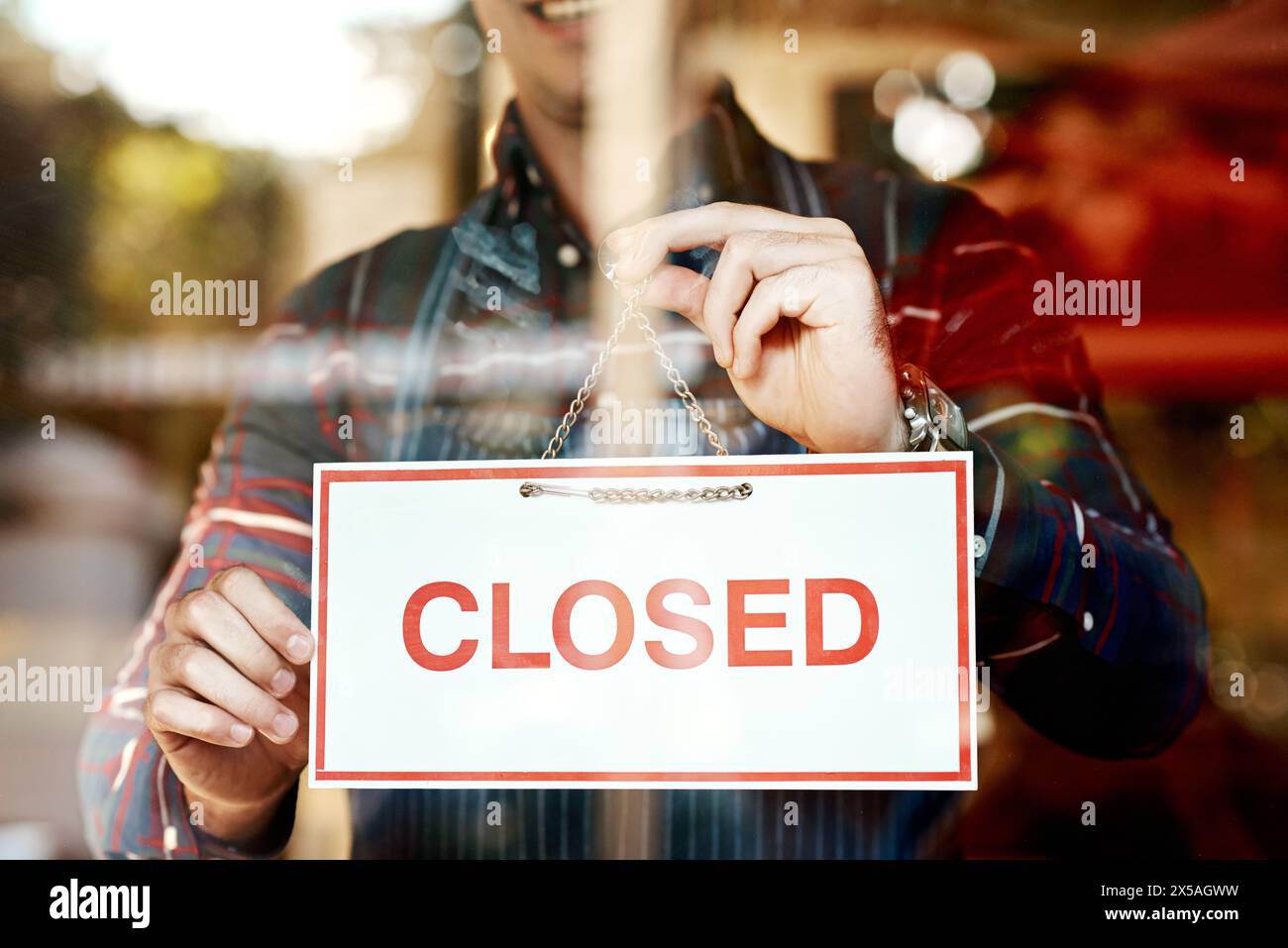 Closed, sign and waiter at door of cafe for information, small business ...