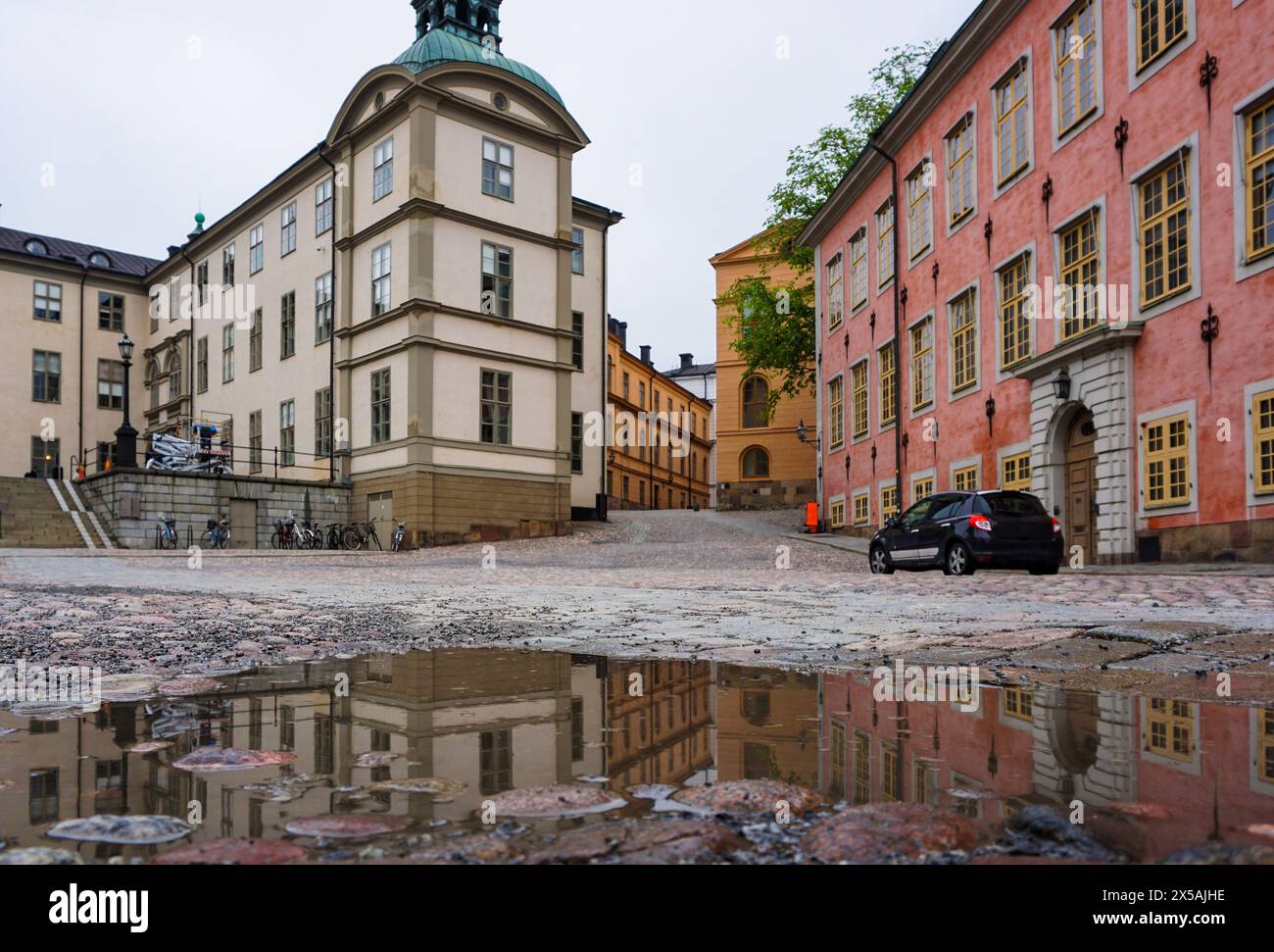 a large puddle of water in a town square Stock Photo - Alamy