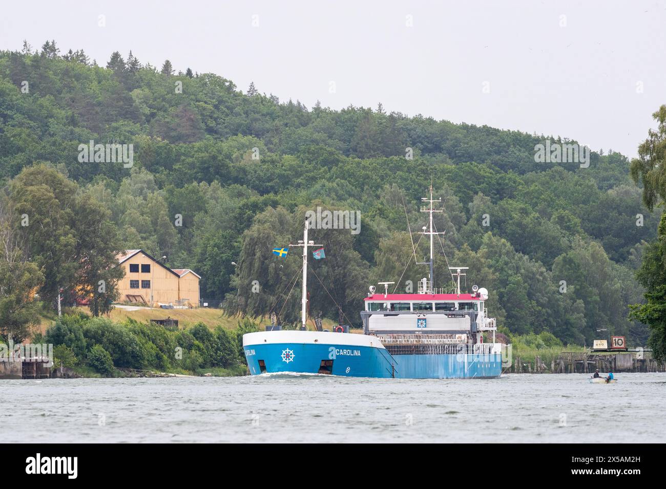 Lilla edet, Sweden - July 16 2023: Freight ship navigating river with ...