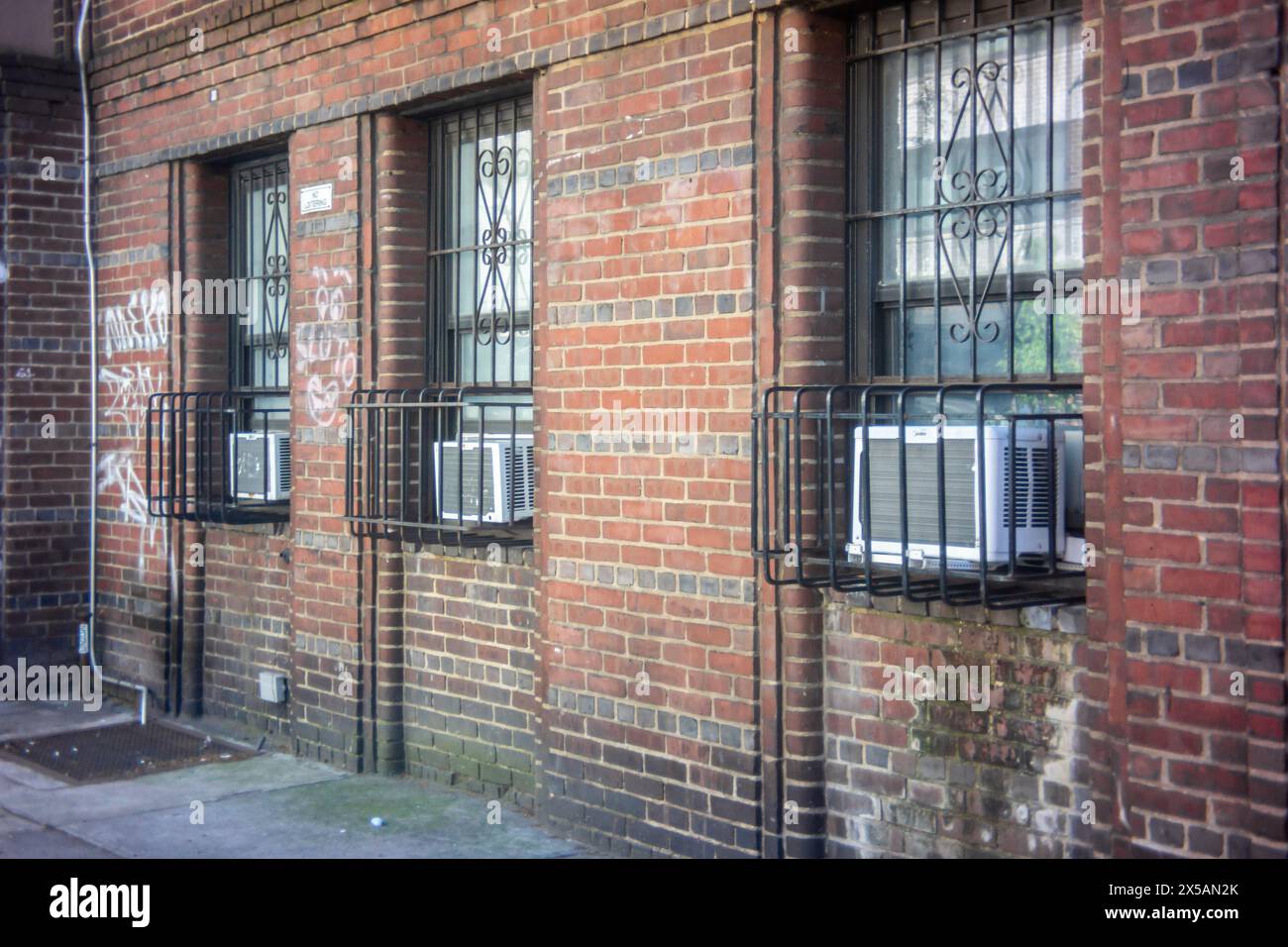 Window air conditioners sprout from first floor windows in a building ...