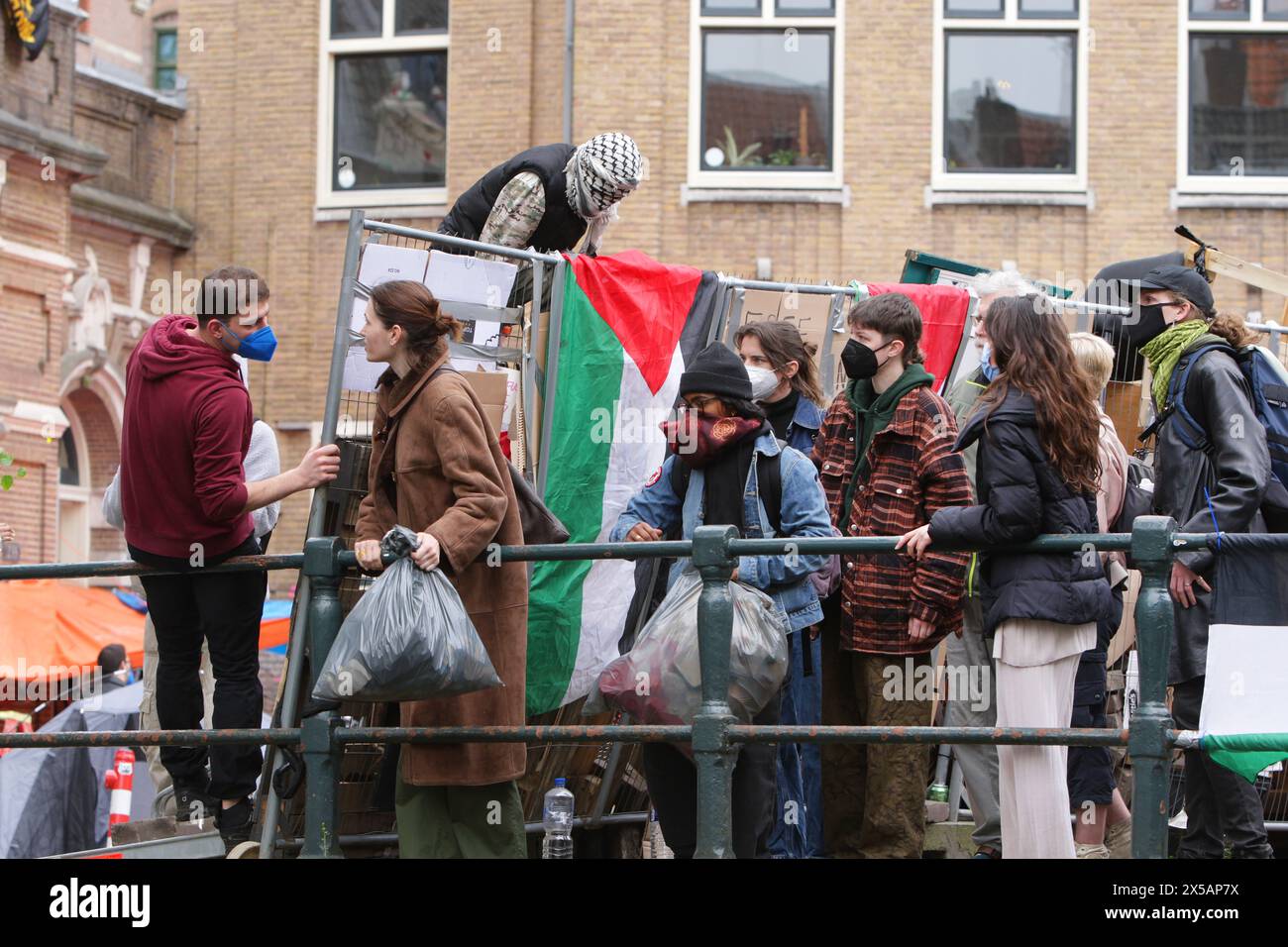 Pro-Palestinian students up a barricade protest against the ongoing ...